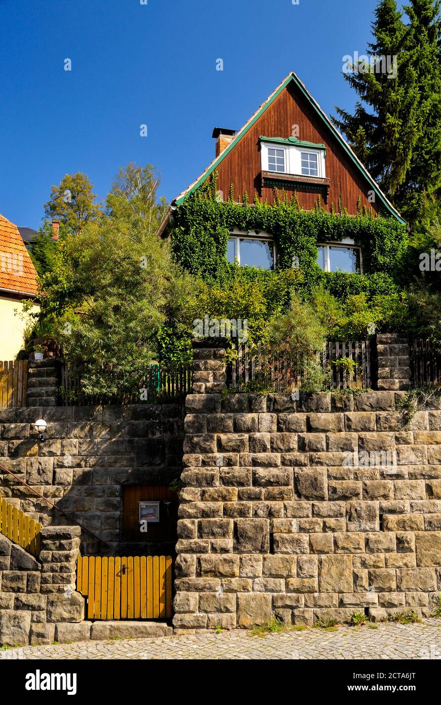 Overgrown house behind stone wall hi-res stock photography and images ...