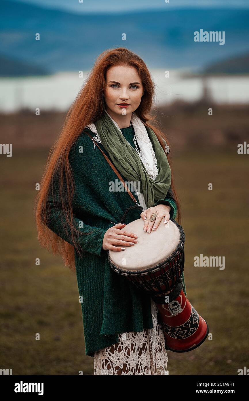 The girl plays the djembe. African drum Stock Photo - Alamy