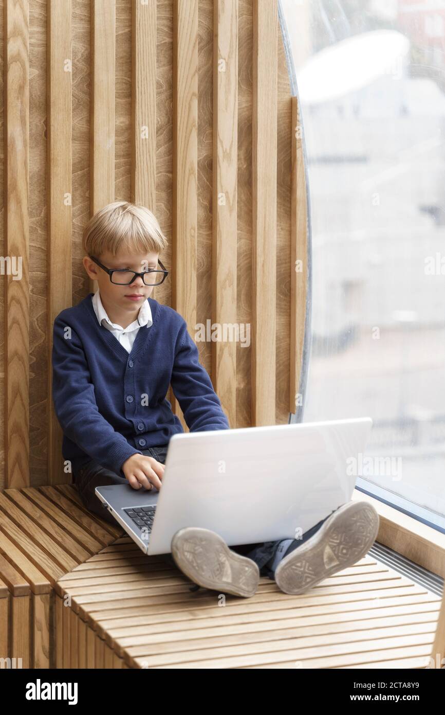 Concentrated boy in glasses gazing at the computer screen Stock Photo ...