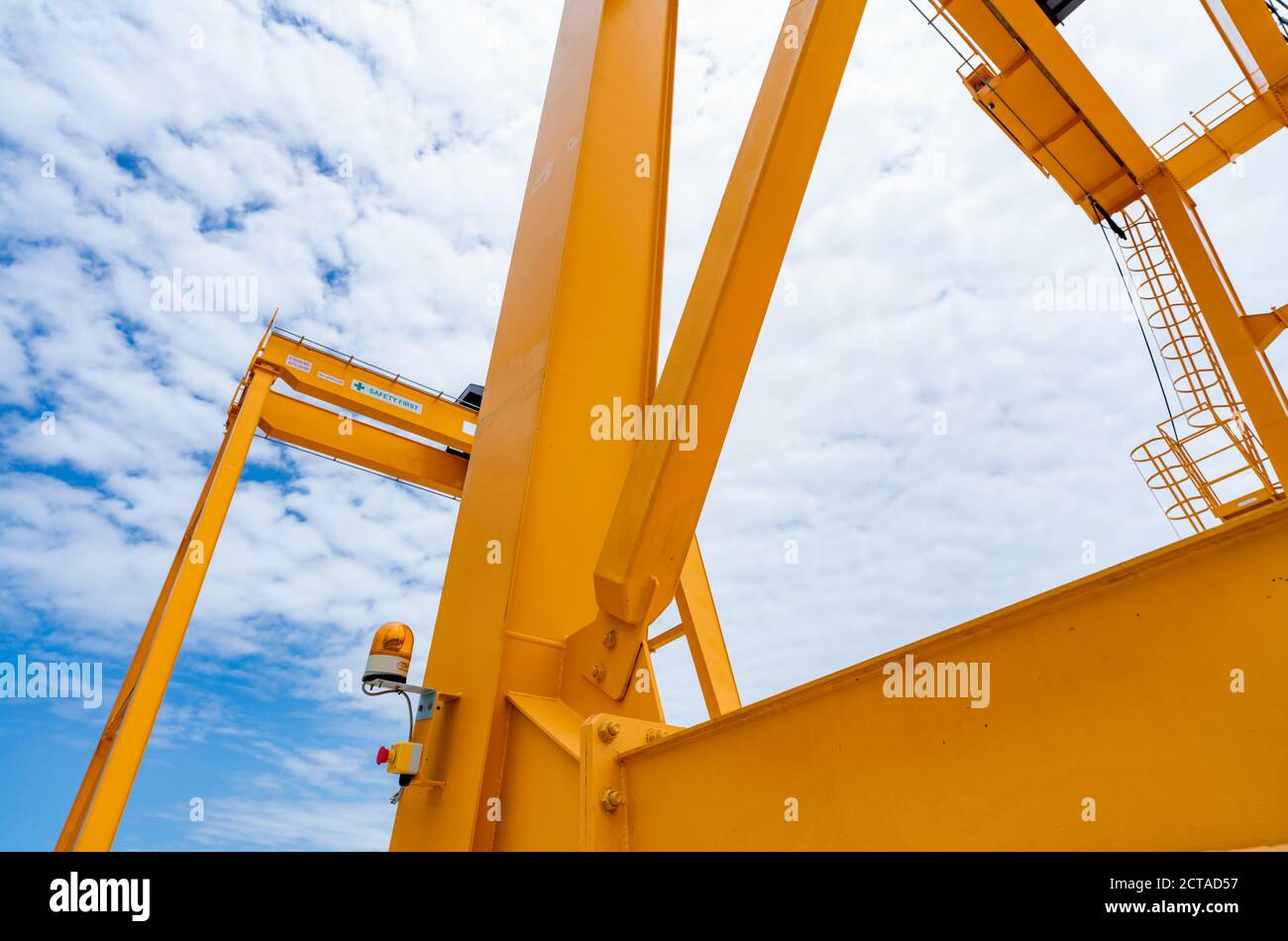 Bottom view of yellow gantry crane against blue sky at port. Gantry ...