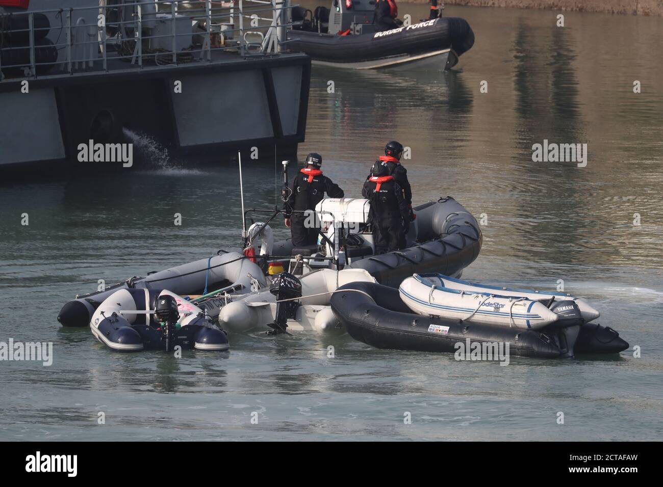 Three border force officers aboard a border force rib hi-res stock ...