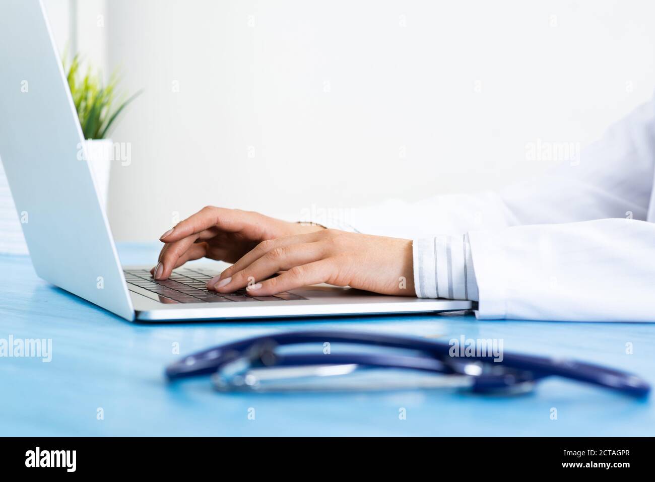 Female therapist typing at laptop keyboard Stock Photo - Alamy
