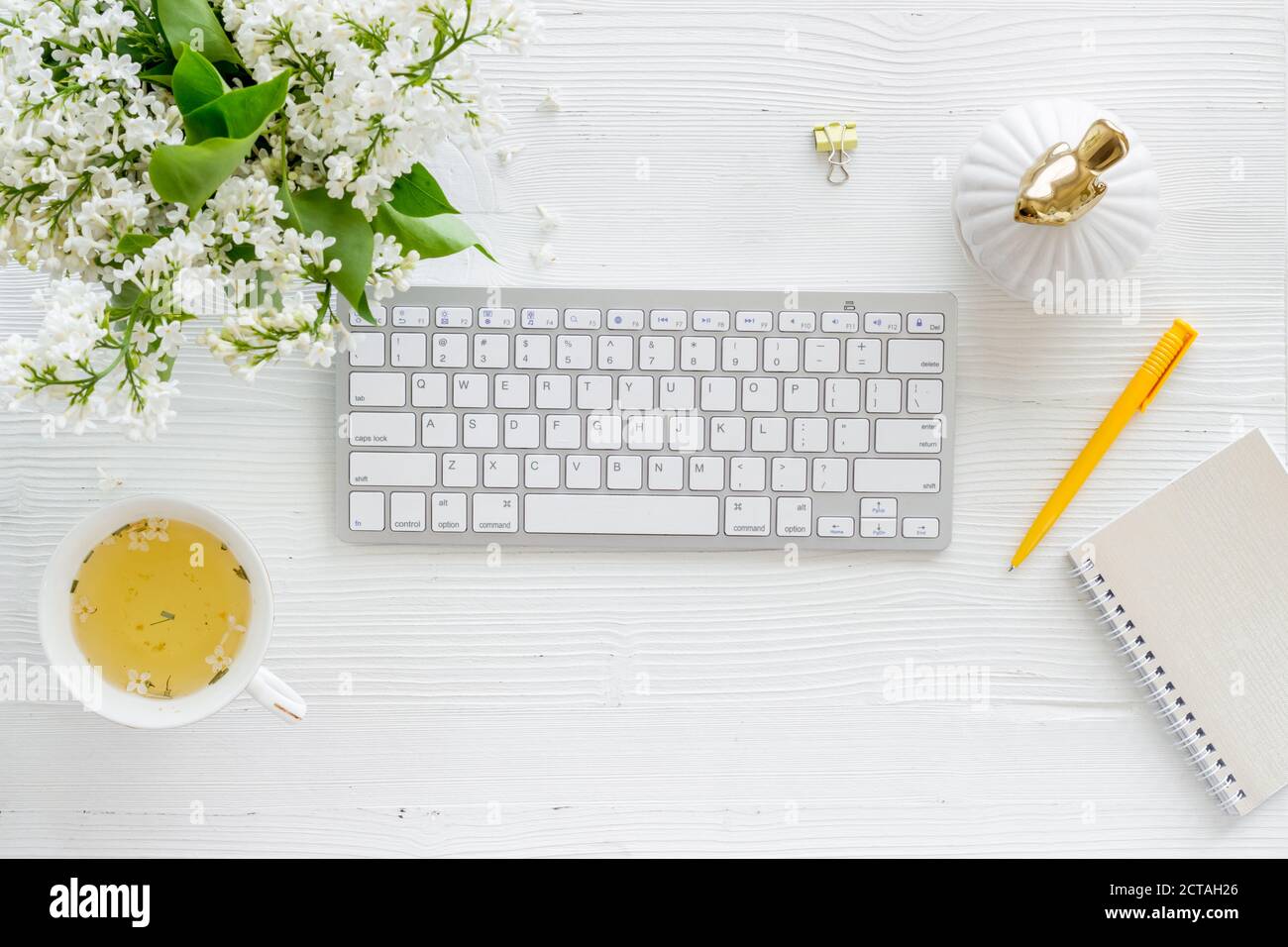Top view of working space with jasmine flowers and computer keyboard ...