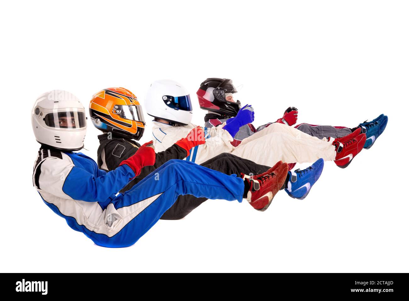 Racing driver in racing position with complete gear isolated in white ...