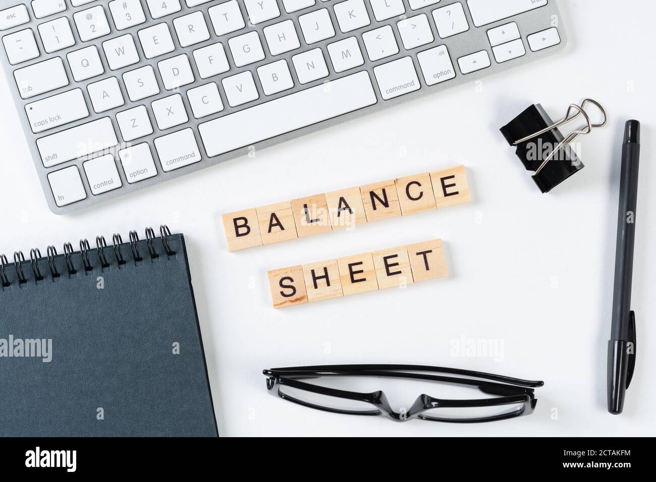 Balance sheet concept with letters on cubes Stock Photo - Alamy