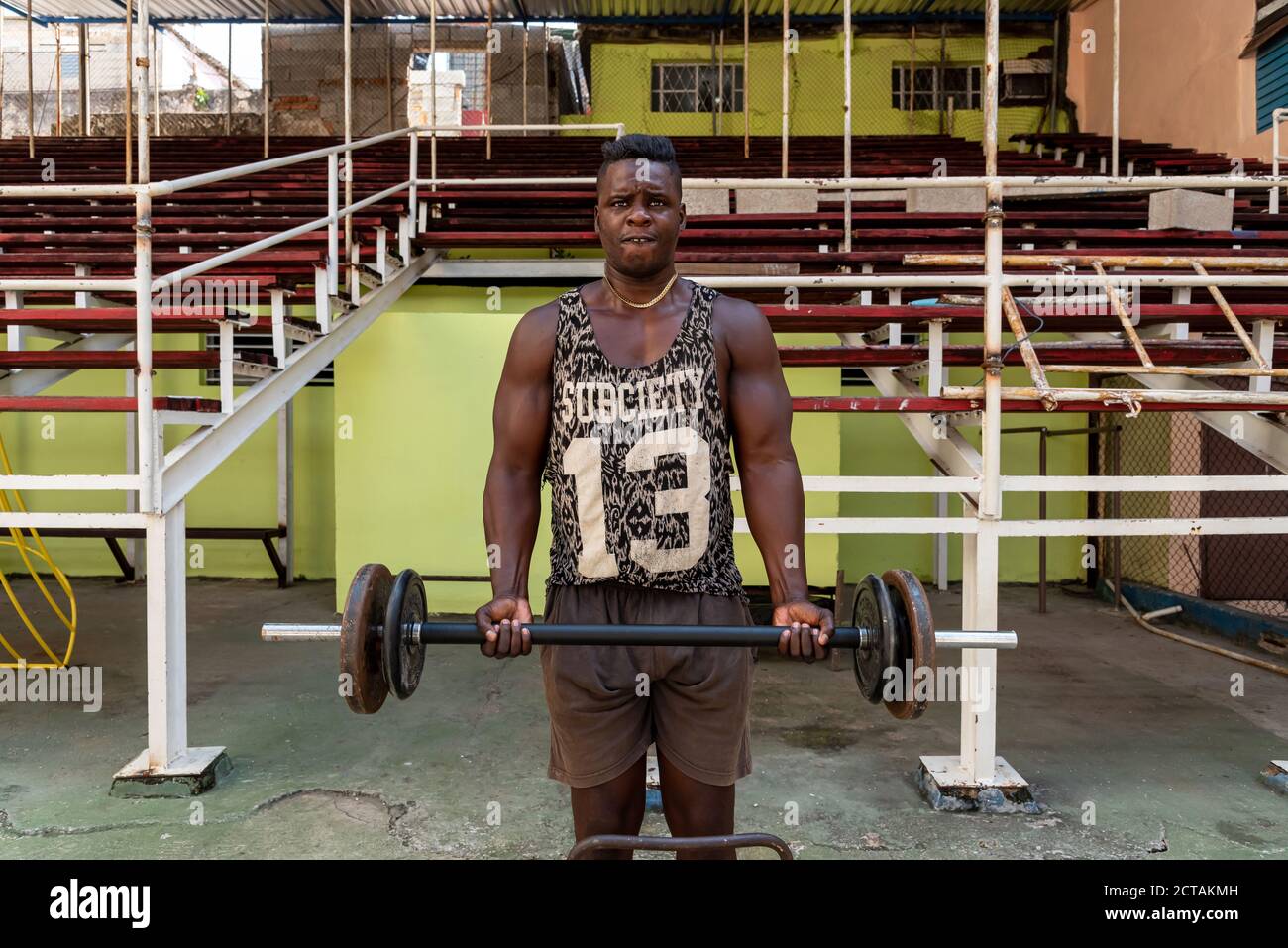 September 4, 2019: Boxer lifting weights in a gym. Havana, Cuba Stock ...