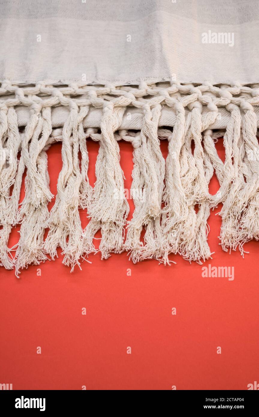 Vertical shot of a knitted cloth on a red surface Stock Photo - Alamy