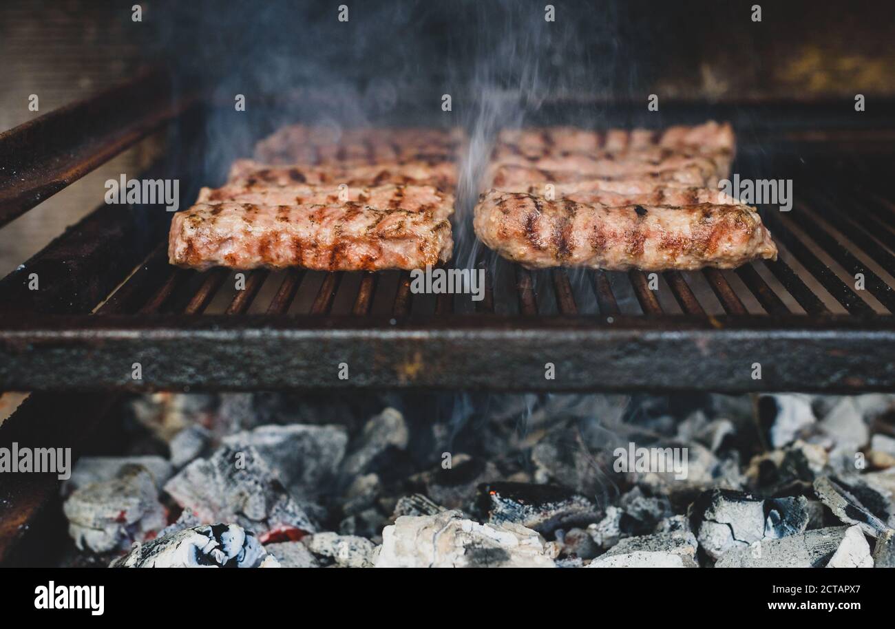 Grilling Meat on barbecue grill with hot coal. Preparing, cooking ...