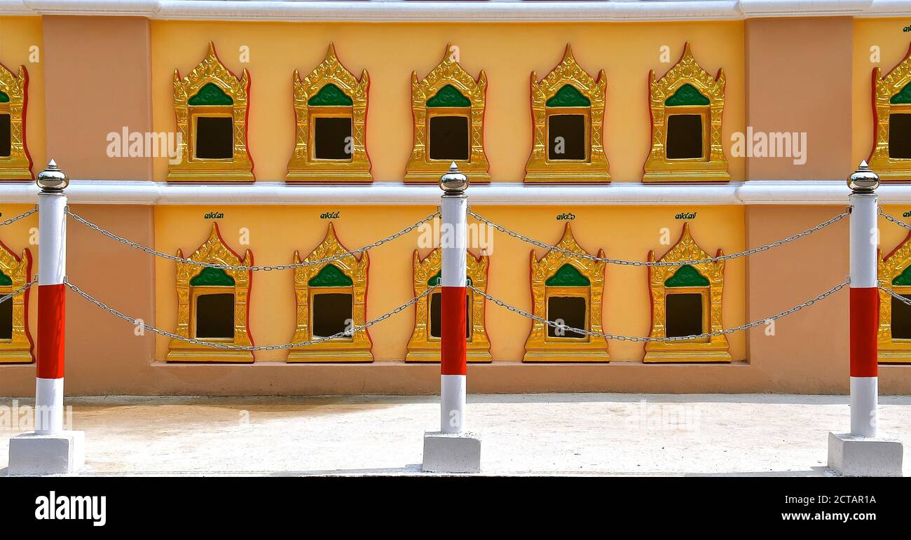 A commemorative wall in a buddhist temple complex in Asia, with spaces ...