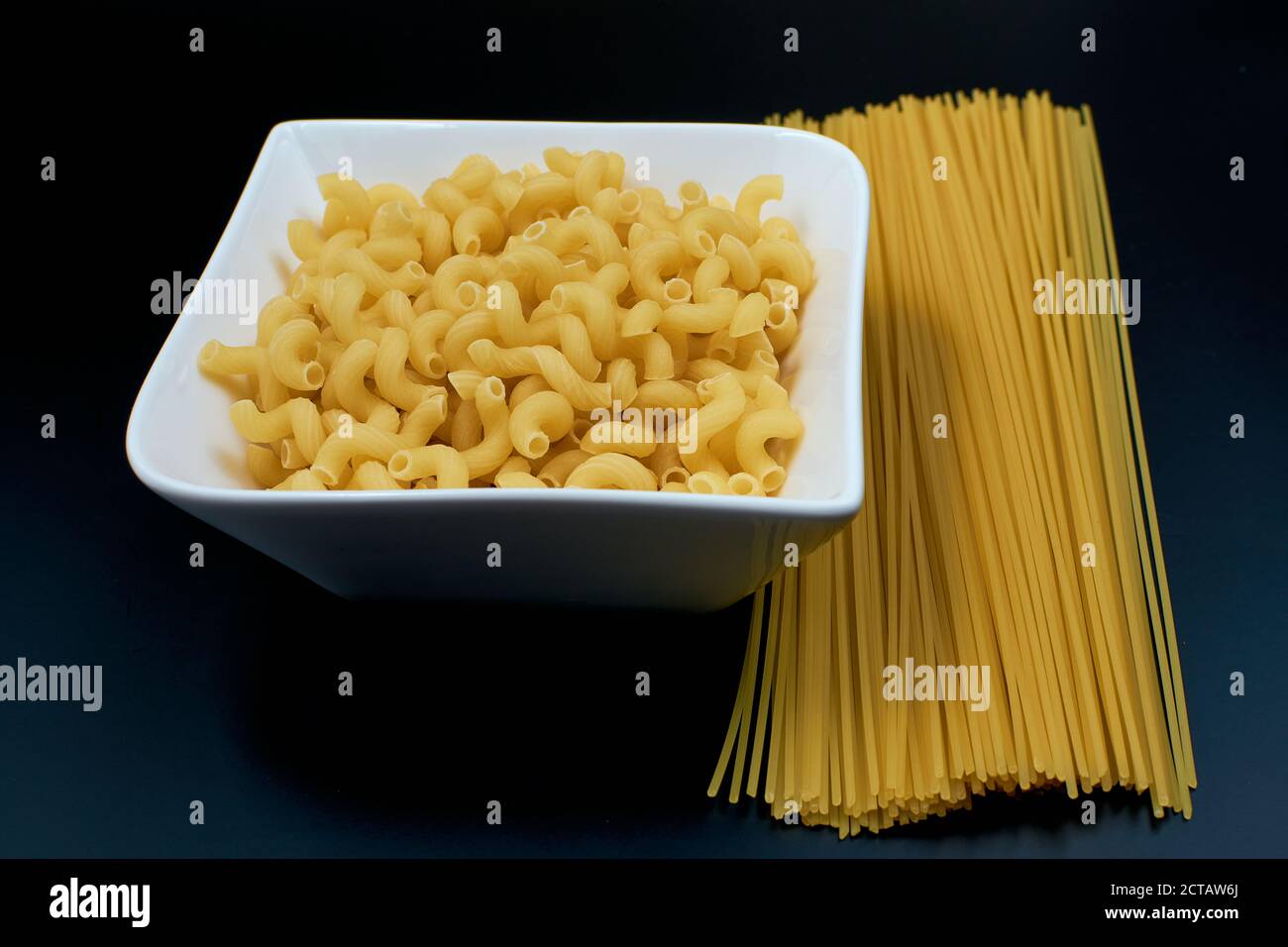 Small pasta in the shape of a spring in a white plate Spaghetti pasta ...