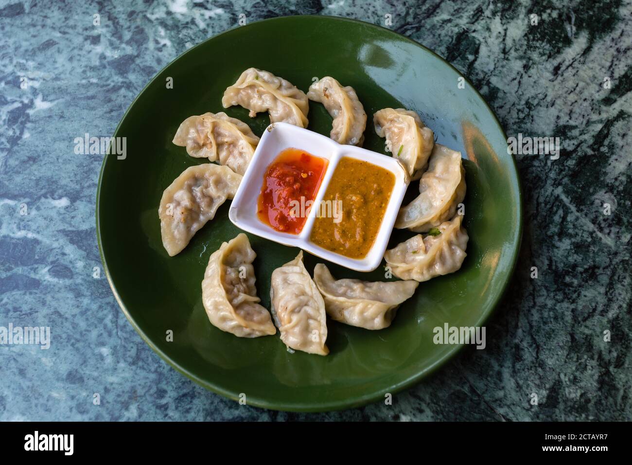 Nepalese steamed dumpling momo served with tomato chutney, traditional ...