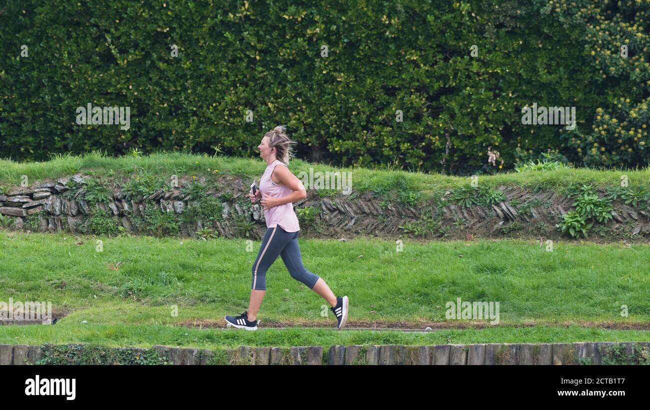 A panoramic image of a woman running in a park Stock Photo - Alamy