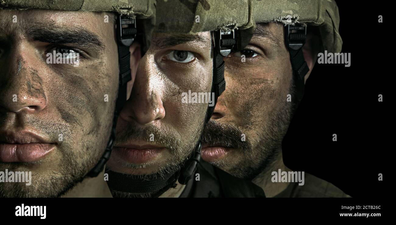 Close up portrait of young male soldiers. Men in military uniform on ...