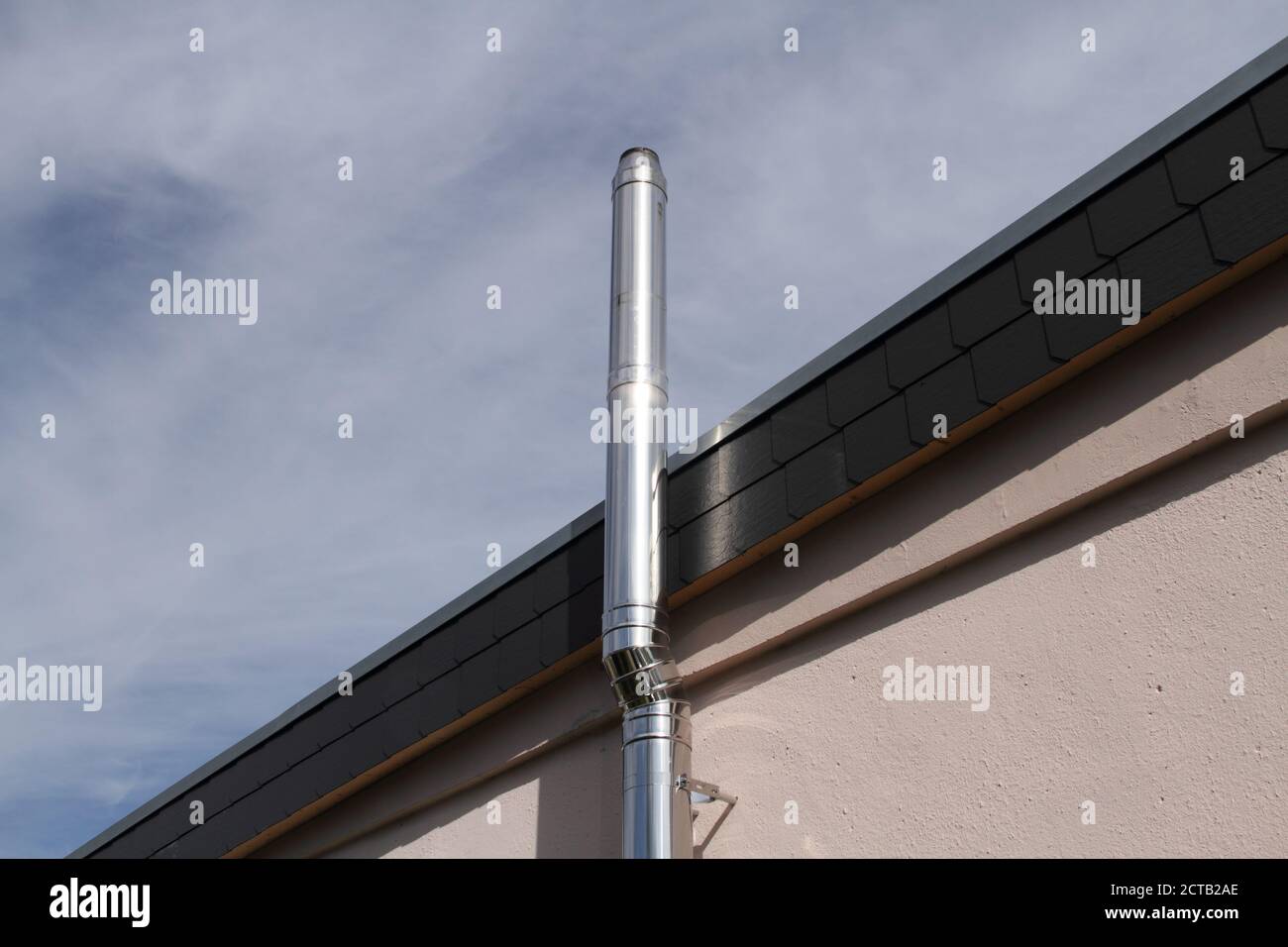 new stainless steel chimney on a house Stock Photo - Alamy