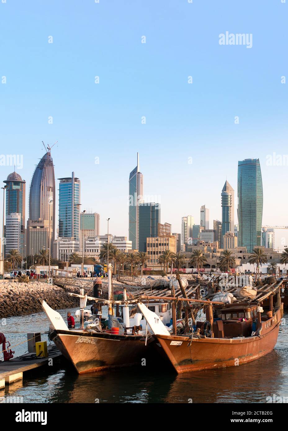 Arabic traditional wooden dhows in front of Kuwait skyscrapers in the ...