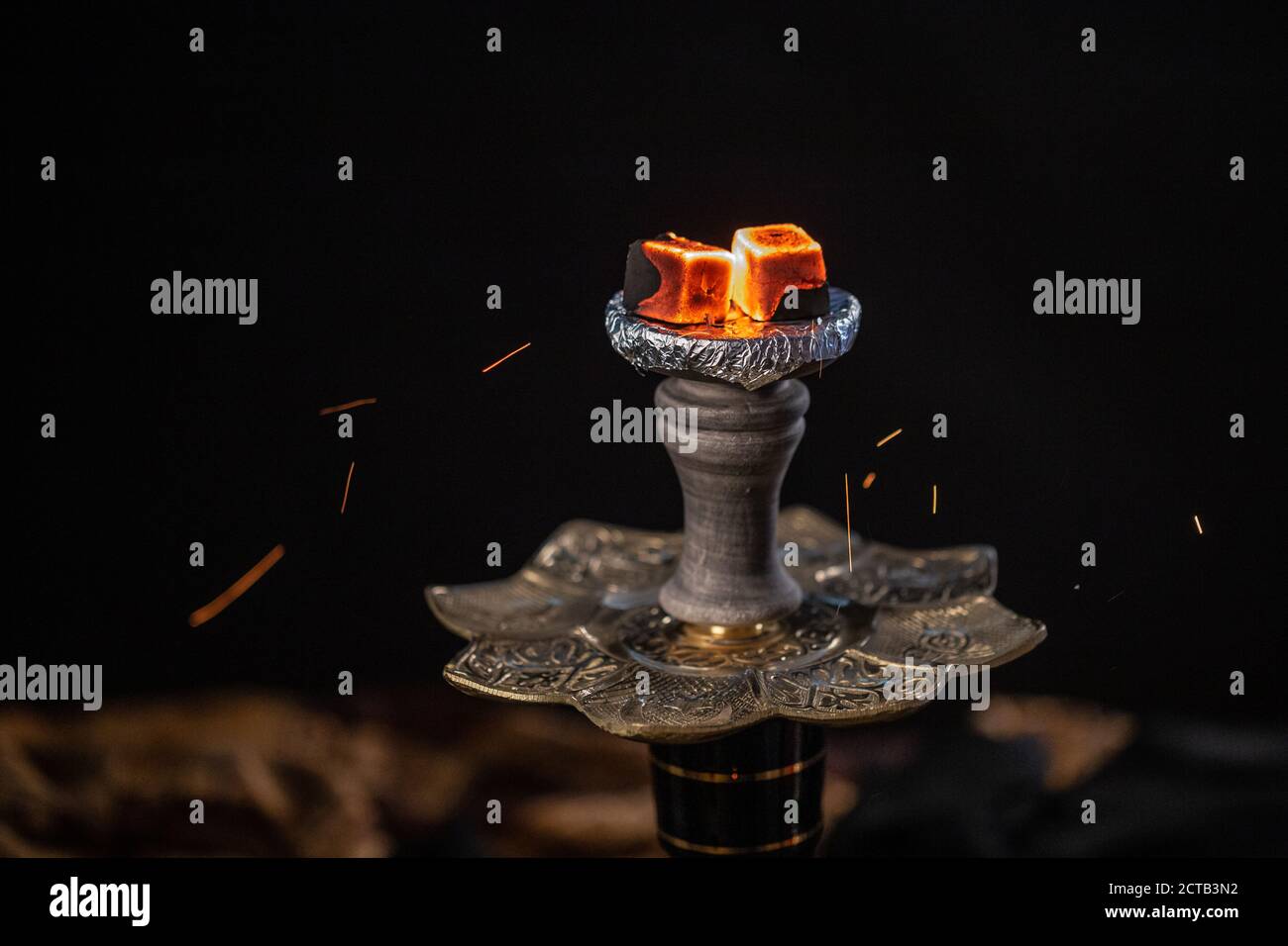 Hot coal in the shisha's bowl with spectacular sparkles. Rustic old ...