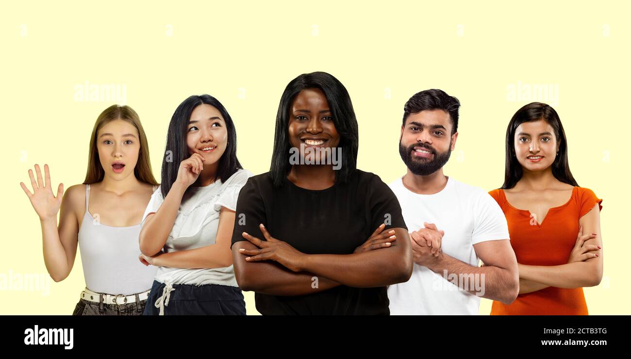 Group portrait of emotional people on yellow studio background. Flyer ...