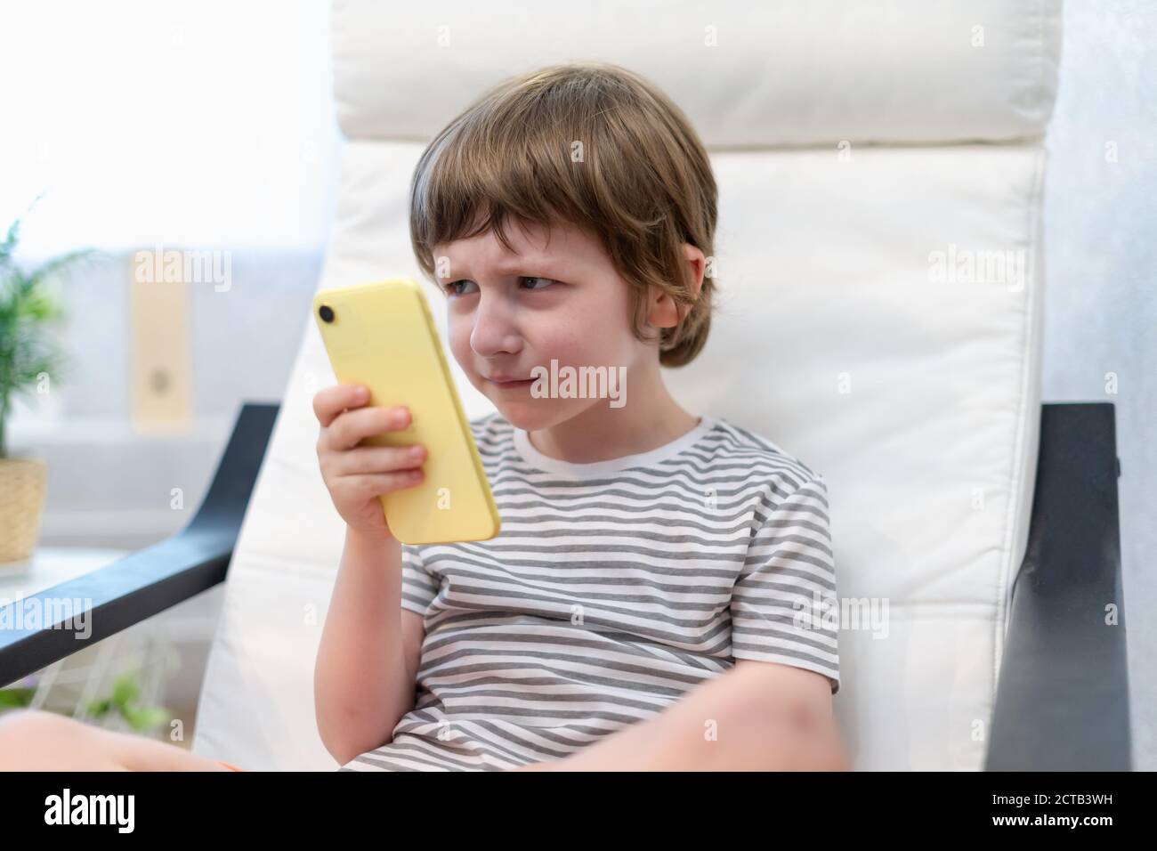 Offended little child boy playing online game, watching video on ...