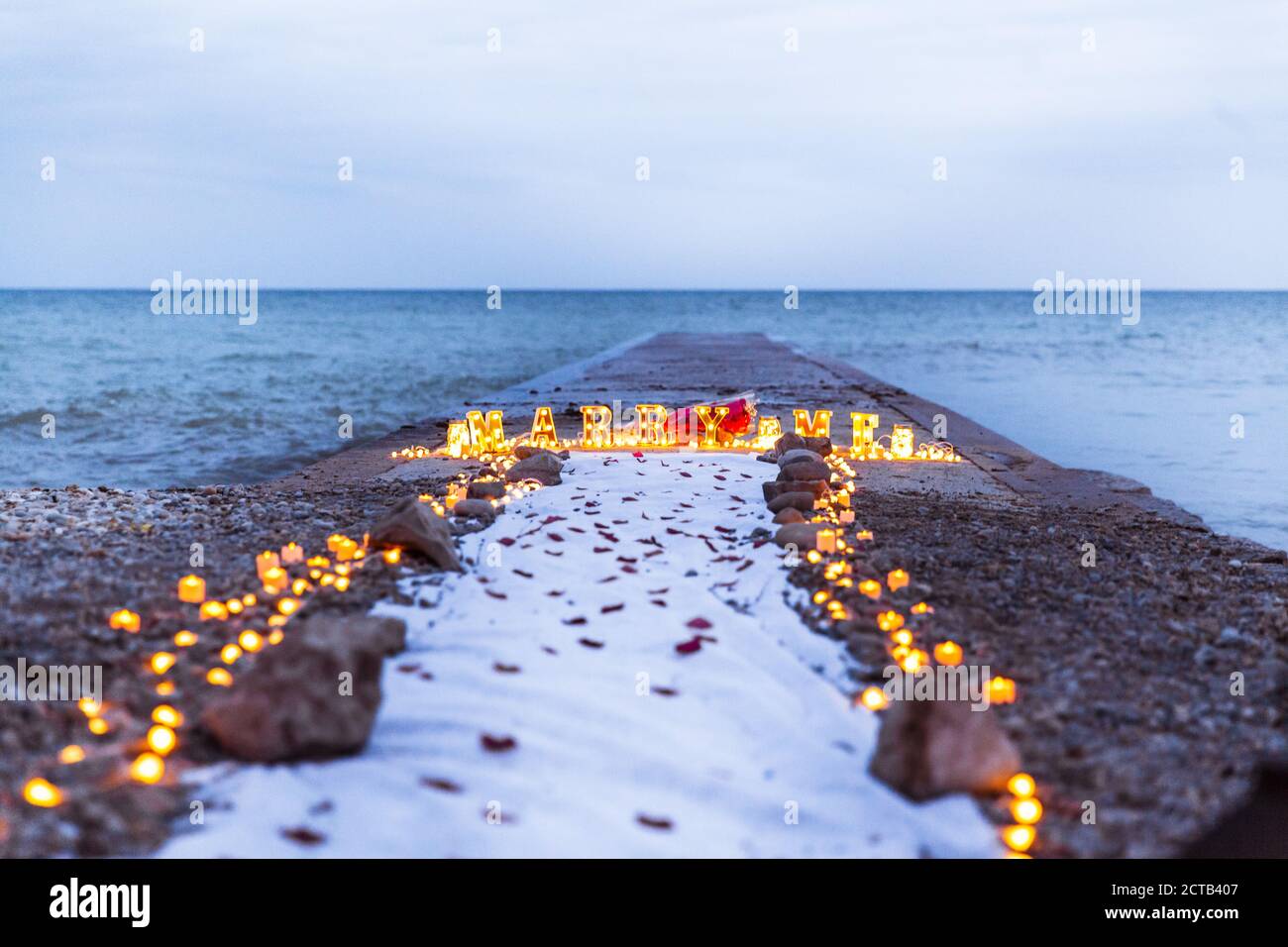 Beautiful proposal setup at a beach with candles Stock Photo - Alamy