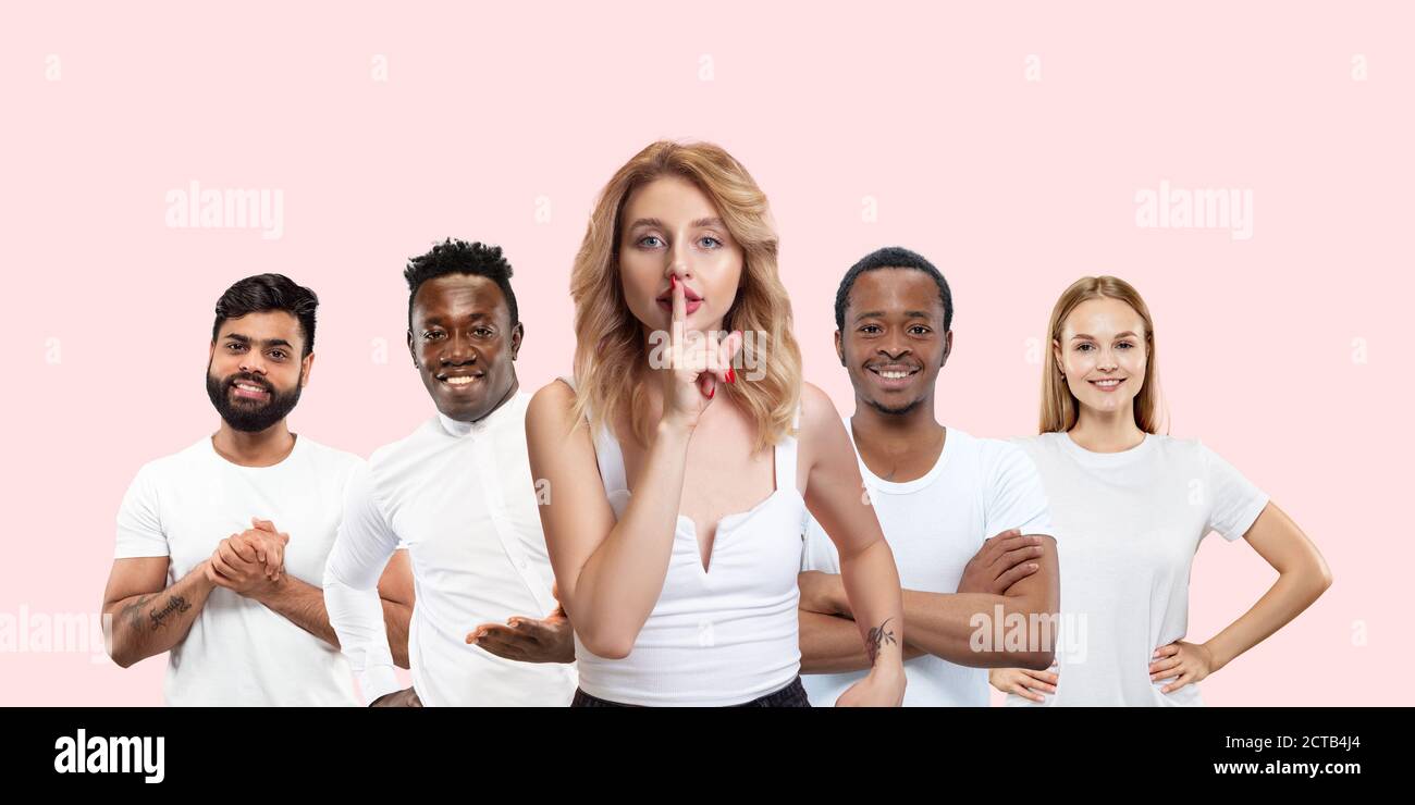 Group portrait of emotional people on coral pink studio background ...