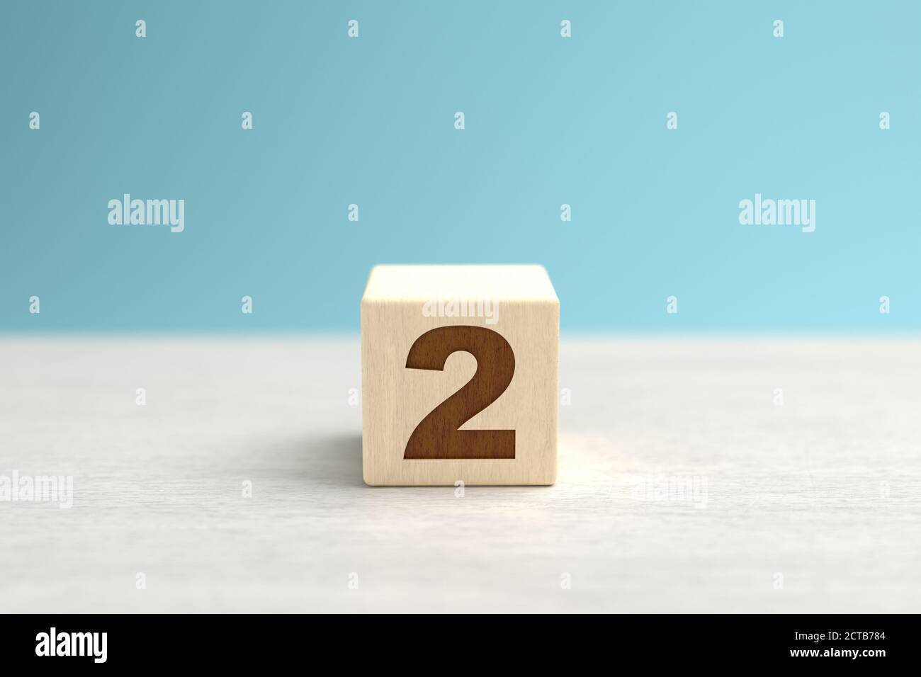 A wooden toy cube with the number 2 Stock Photo - Alamy