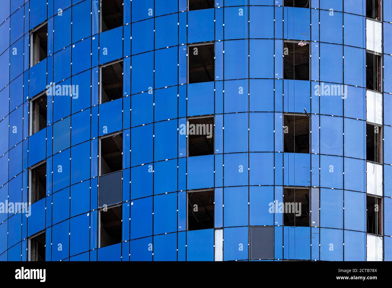 Fragment of an unfinished building under construction with blue ...