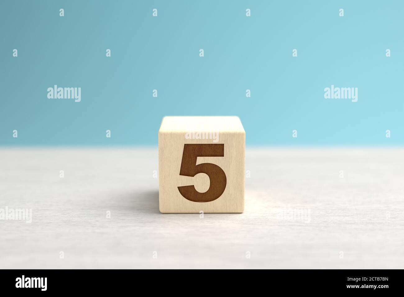 A wooden toy cube with the number 5 Stock Photo - Alamy