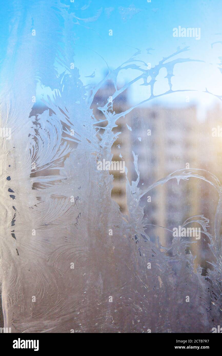 Frozen winter window with shiny ice frost pattern texture. Christmas ...