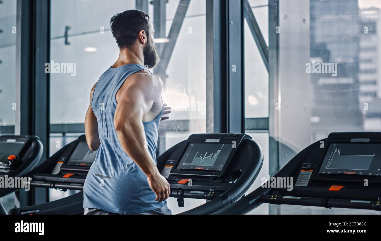 Athletic Muscular Man Running on a Treadmill, Leg and Cardio Day ...