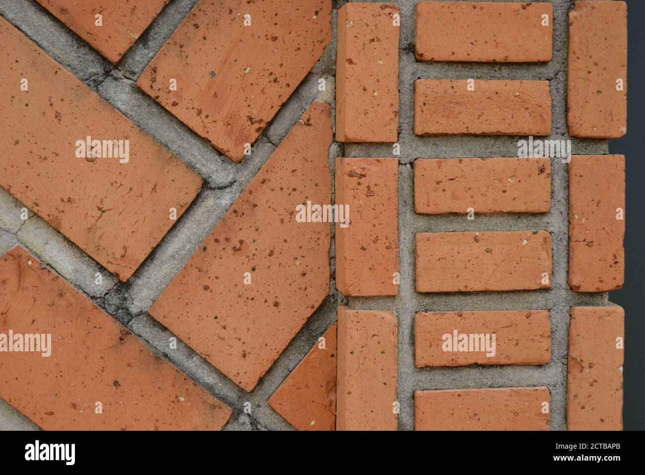 Brick wall, forming a coating of small architectural figures with ...