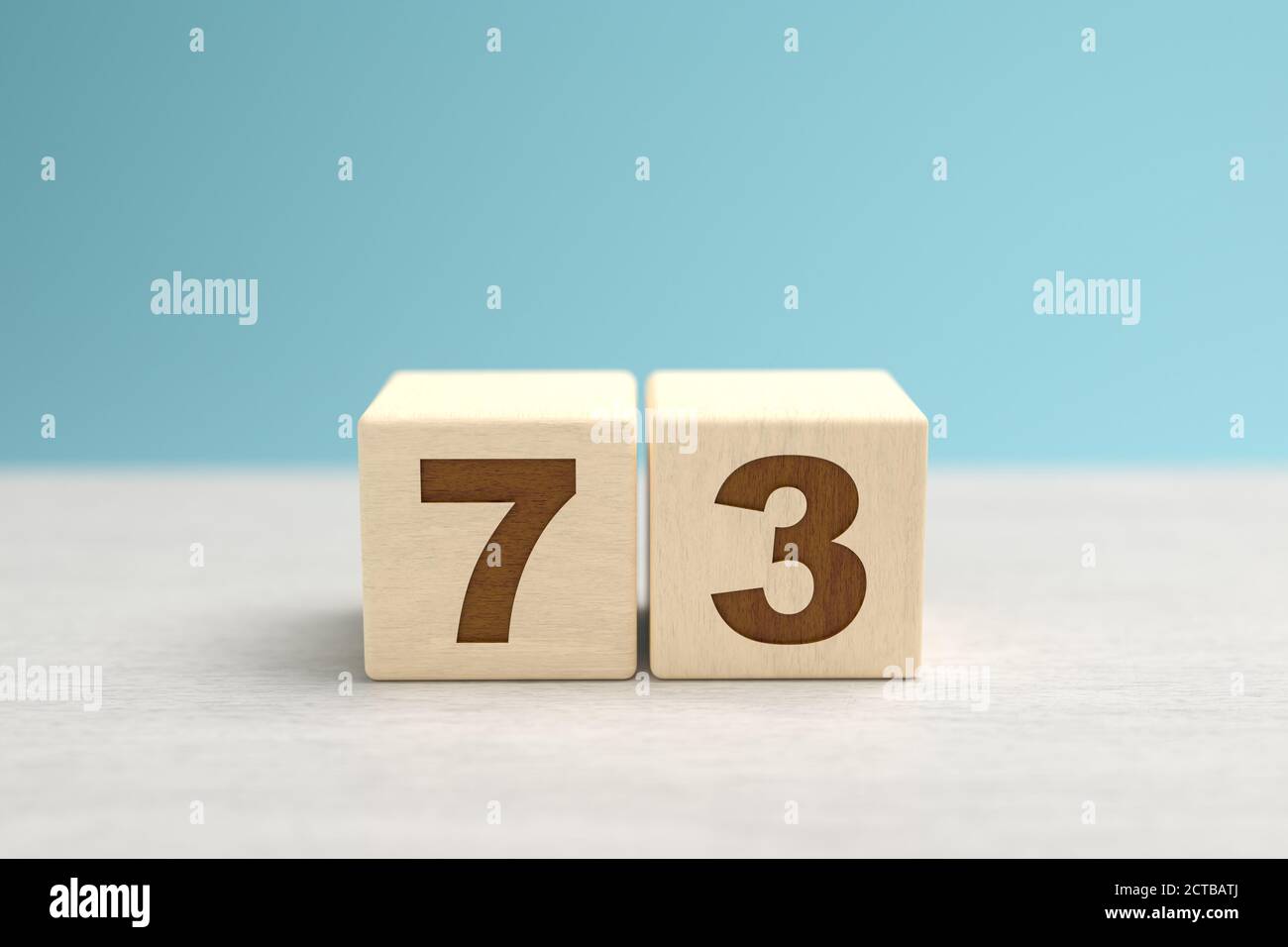 Wooden toy blocks forming the number 73 Stock Photo - Alamy