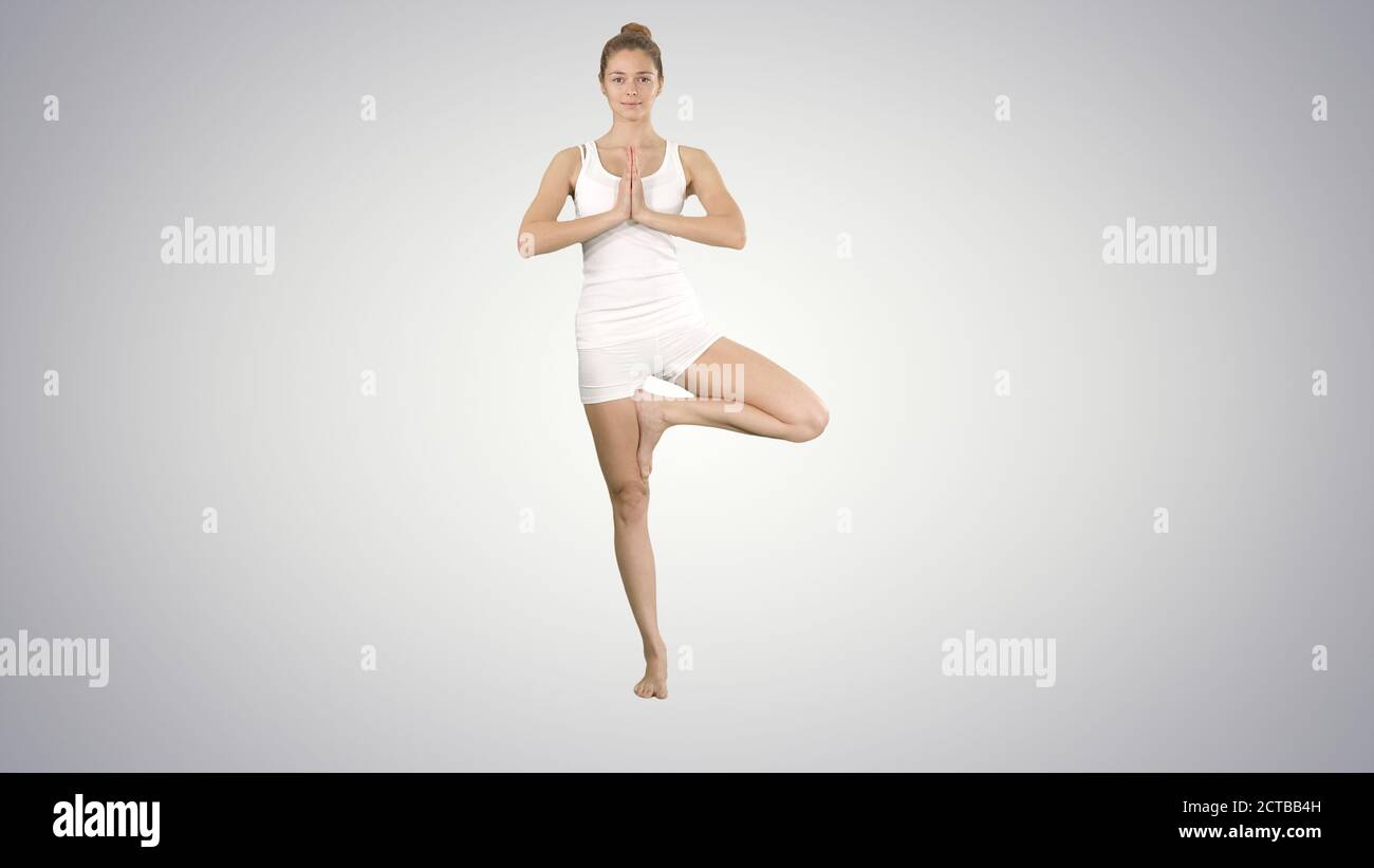 Tree pose, standing on one leg, hands in Namaste, prayer gesture Stock ...