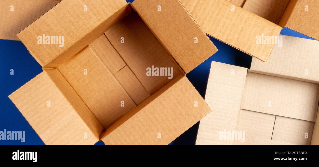 Empty open cardboard boxes on blue background. Top view Stock Photo - Alamy
