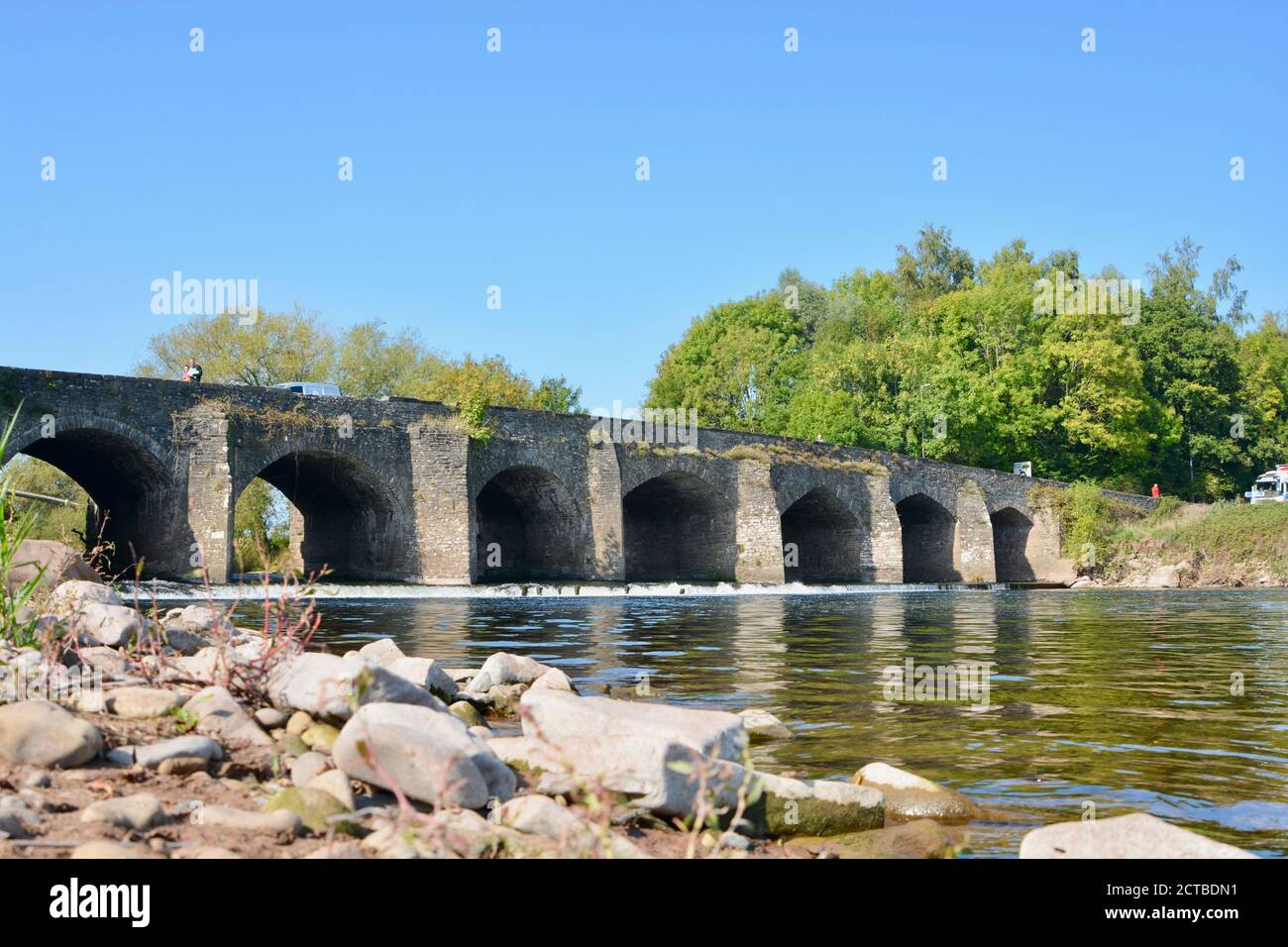 The Usk River in Abergavenny, ancient bridge spanning the river which ...