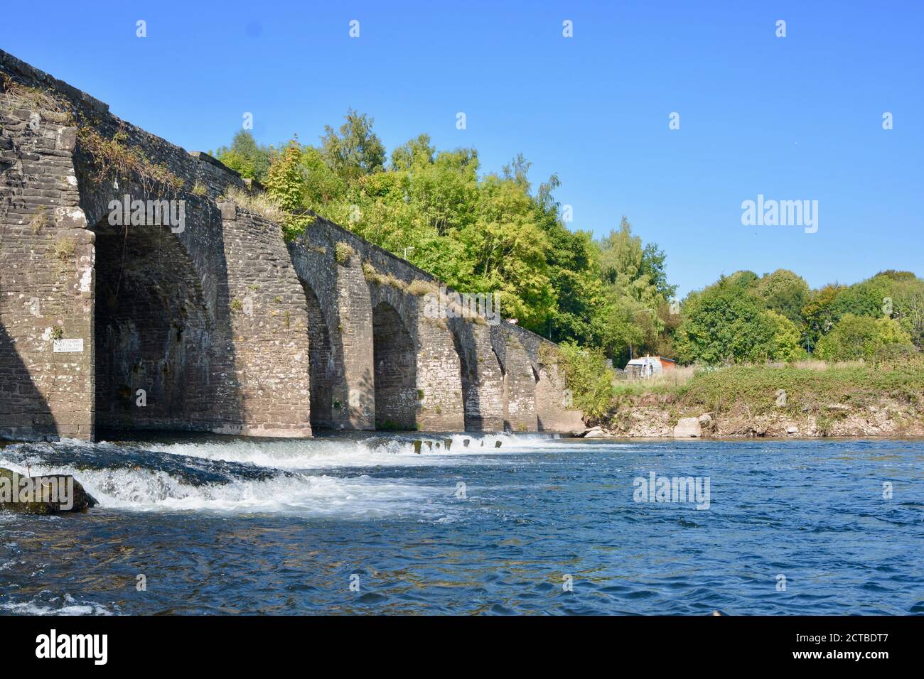The Usk River in Abergavenny, ancient bridge spanning the river which ...