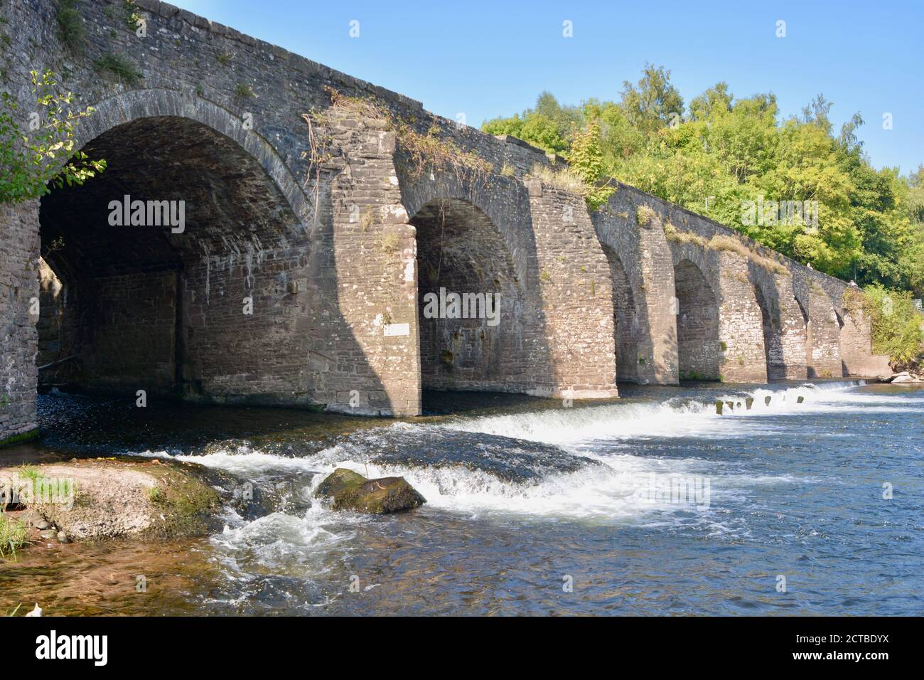 The Usk River in Abergavenny, ancient bridge spanning the river which ...