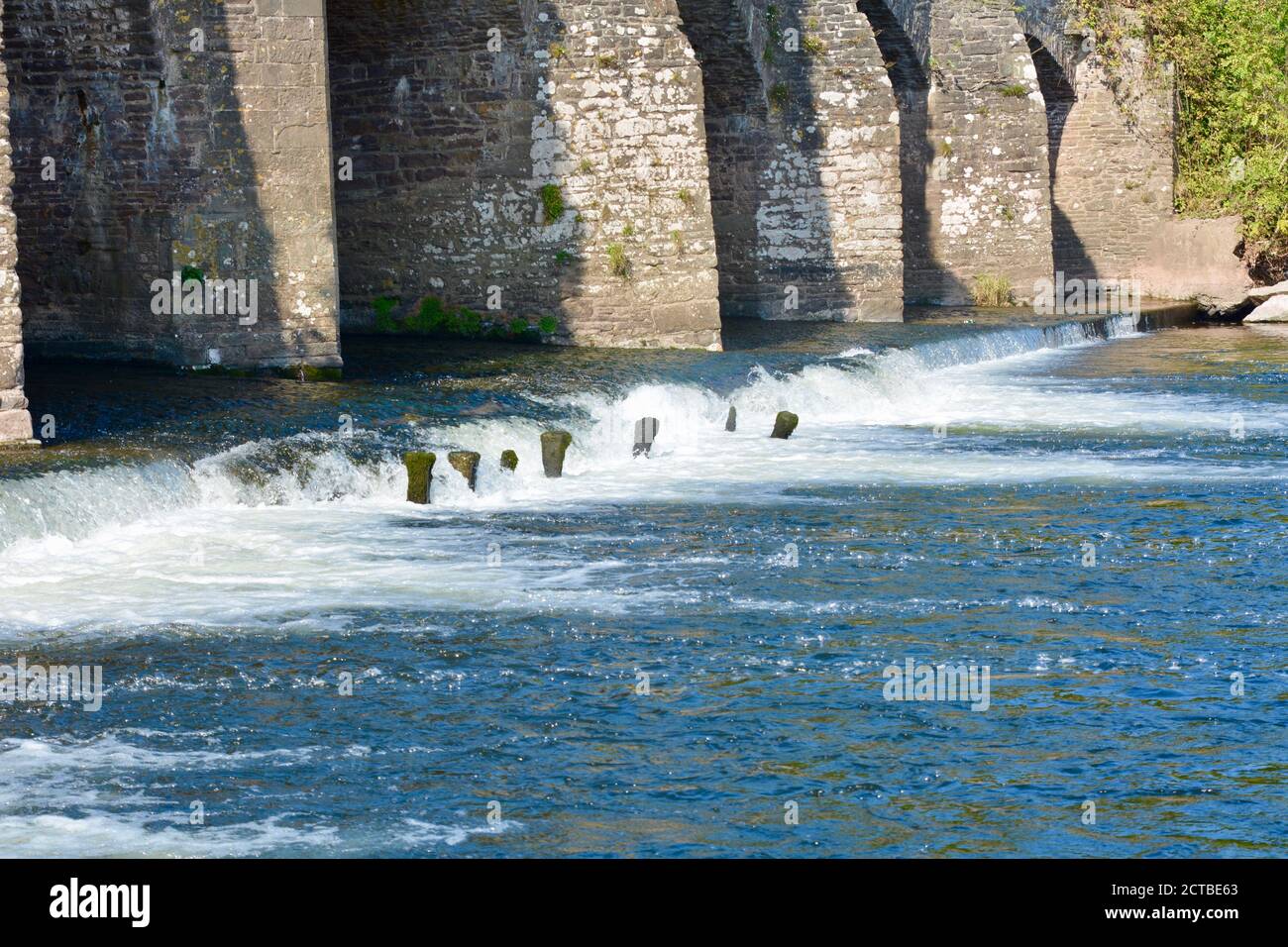 The Usk River in Abergavenny, ancient bridge spanning the river which ...