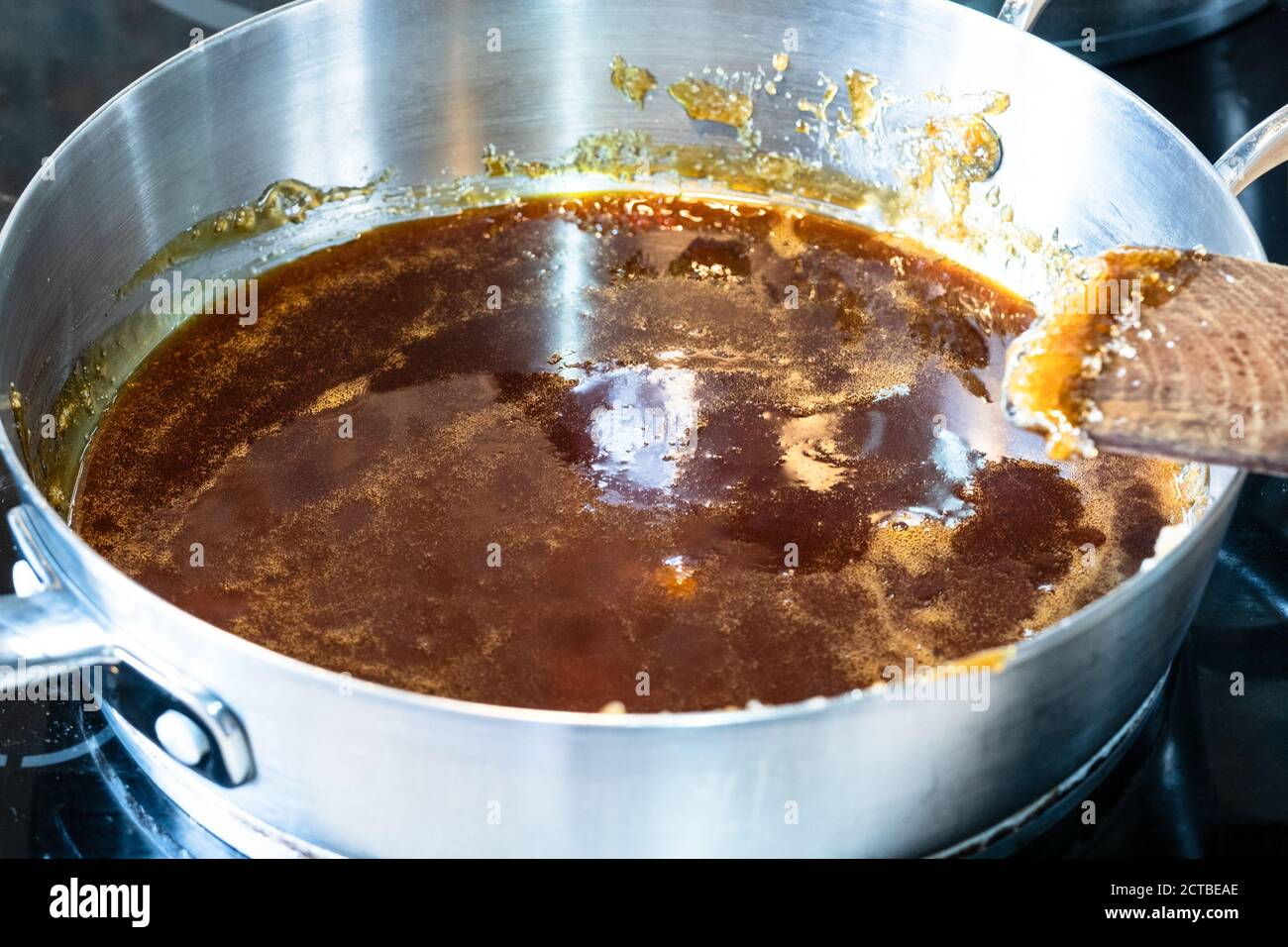 cooking salted butter caramel sauce at home kitchen - melted sugar in ...