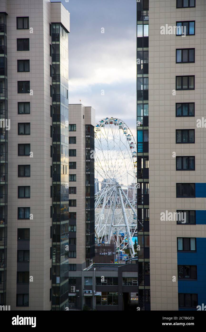 the ferris wheel and sparkling high rise downtown buildings Stock Photo ...
