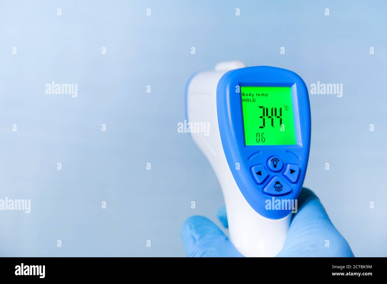 Hand holding infrared thermometer to measuring temperature Stock Photo ...