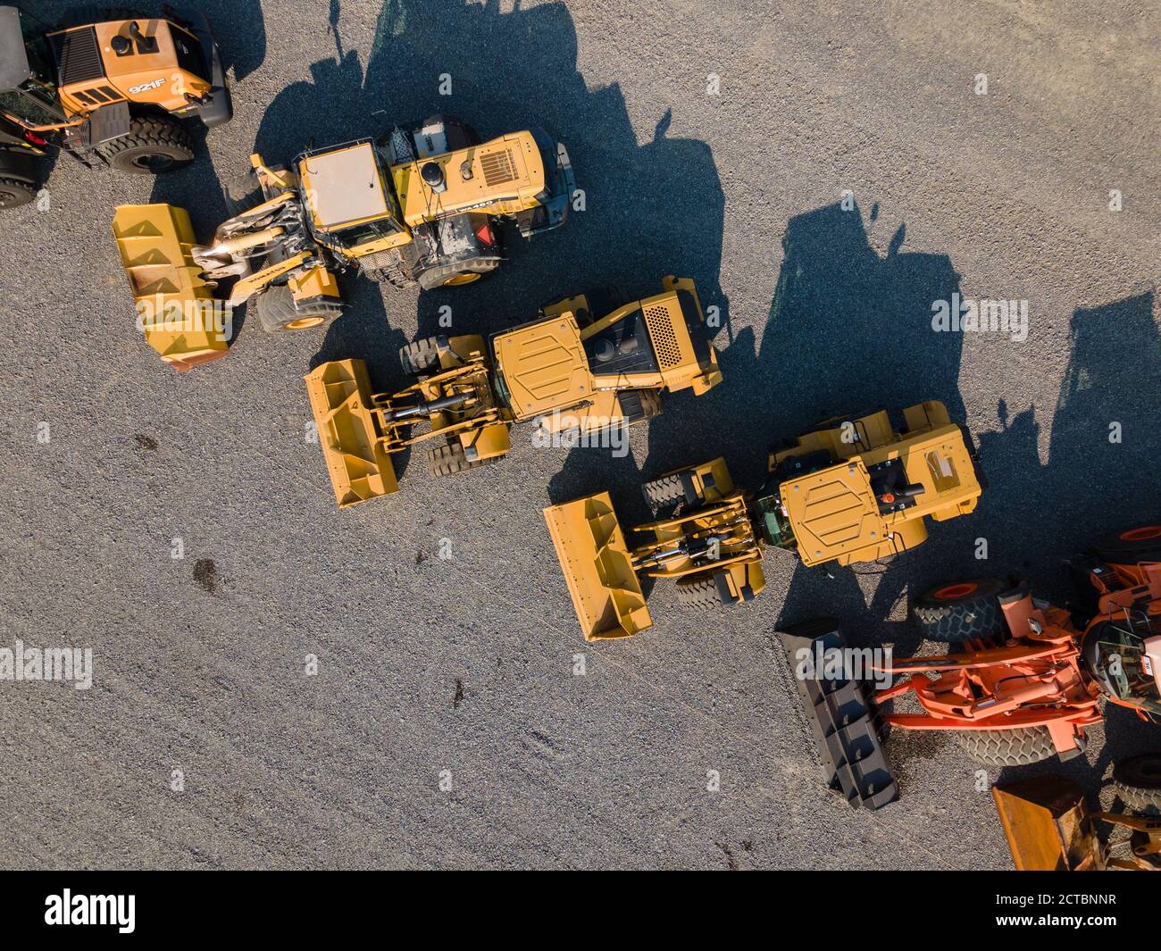 Aerial view of a perfect row of wheel loaders Stock Photo - Alamy