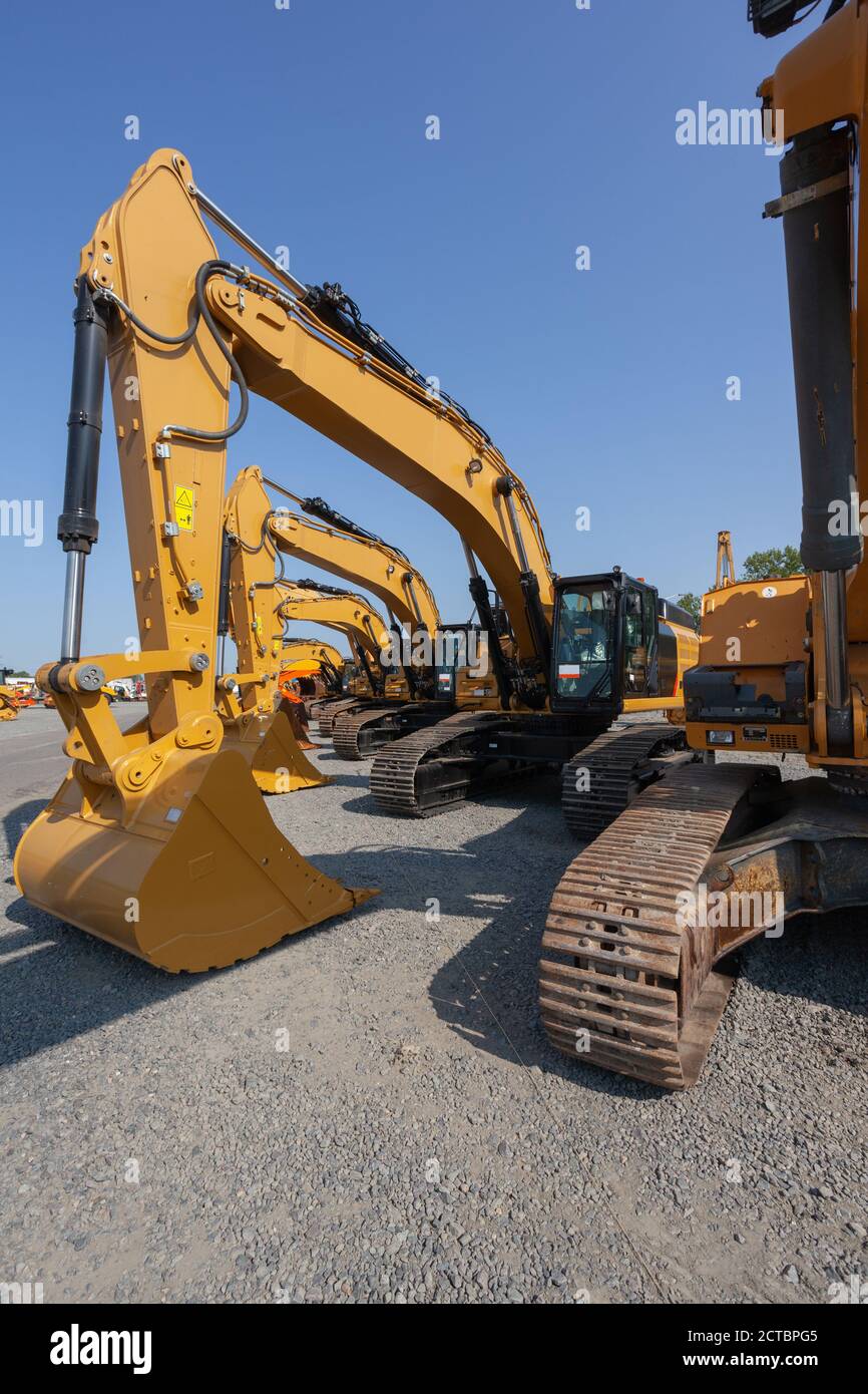 Vertical shot of a row of excavators in a construction site Stock Photo ...