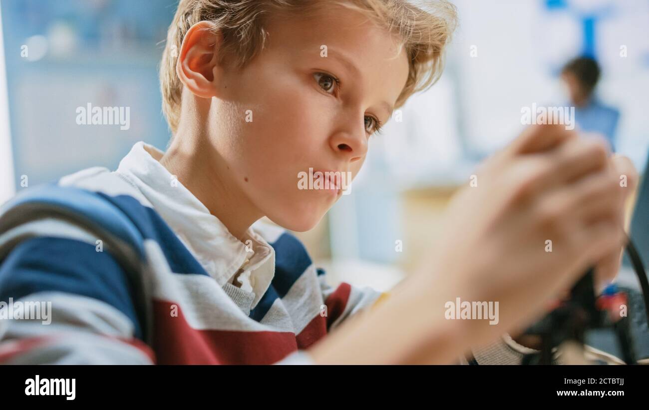 Portrait Shot of a Smart Schoolboy Constructs Small Robot for Robotics ...