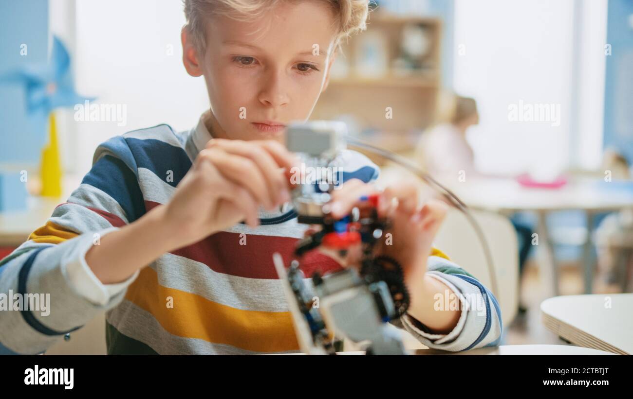 Portrait Shot of a Smart Schoolboy Constructs Small Robot for Robotics ...