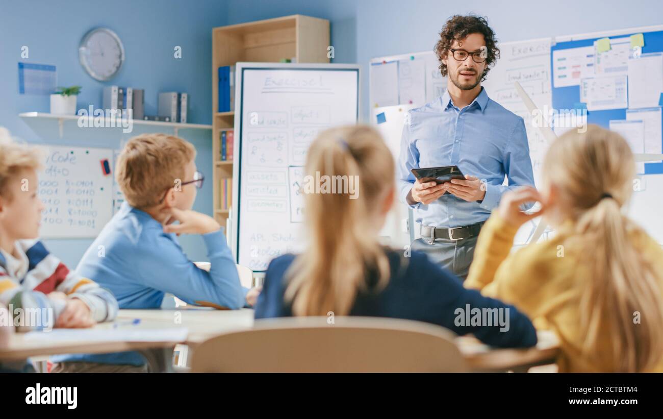 Enthusiastic Teacher Explains Lesson to a Classroom Full of Bright ...