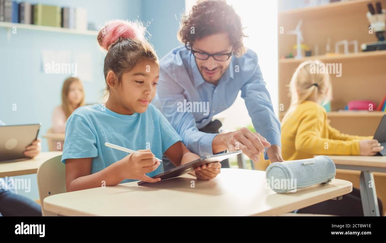 Elementary School Computer Science Class: Cute Girl Uses Digital Tablet ...