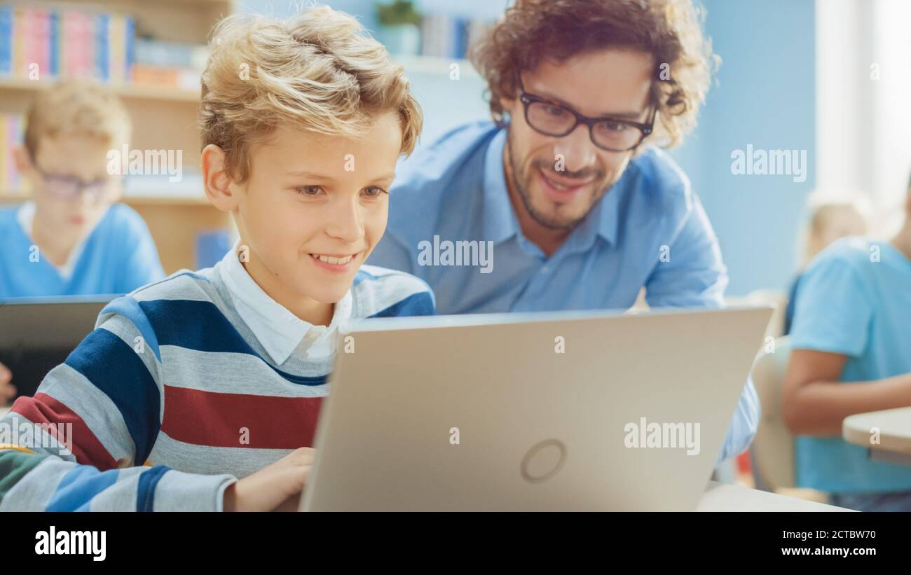 Elementary School Computer Science Class: Smart Boy Uses Laptop ... Elementary School Computer Science Class: Smart Boy Uses Laptop ...