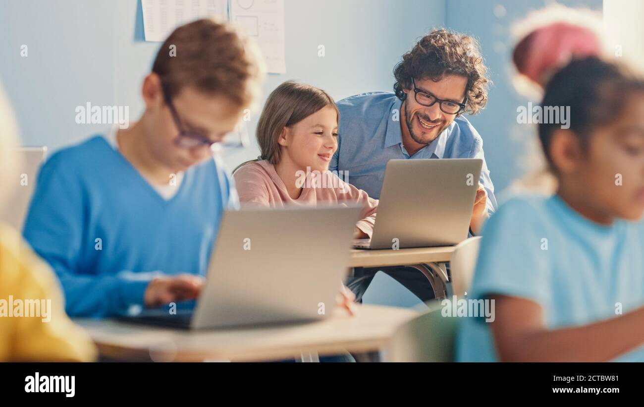 Elementary School Computer Science Class: Smart Girl Uses Laptop ...