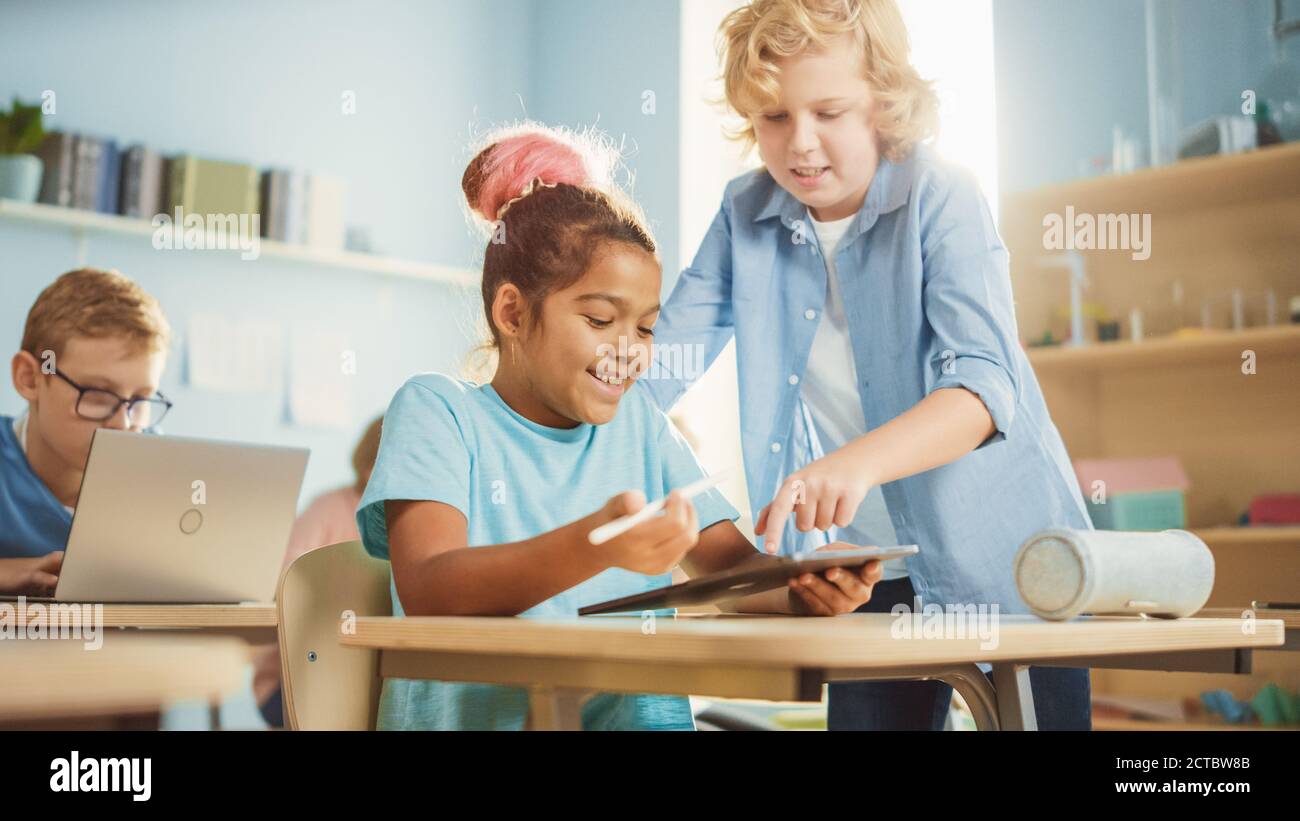 Elementary School Computer Science Class: Smart Girl Uses Digital ...