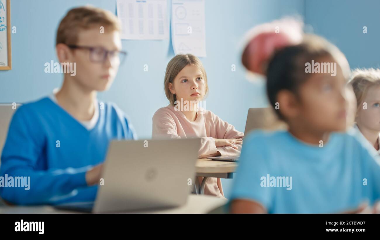 Elementary School Computer Science Class: Cute Girl Uses Digital Tablet ...